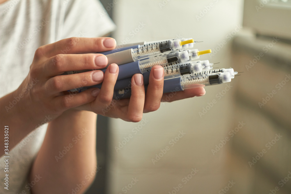 Diabetes insulin dependent concept, hands with syringes pen injectors ... Diabetes insulin dependent concept, hands with syringes pen injectors ...