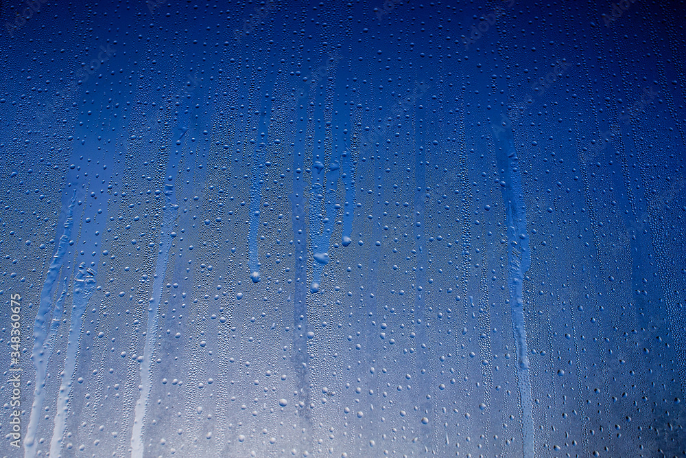 patterns on glass, frosty drawings in winter on a window, blue ...