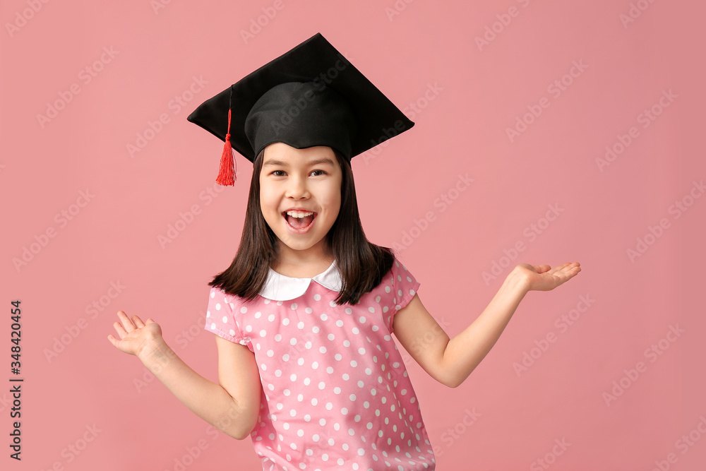 Little girl in graduation hat on color background Stock Photo | Adobe Stock