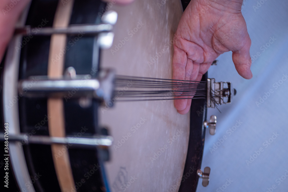 Antique snare drum with black shell. Side view with hand in shot ...
