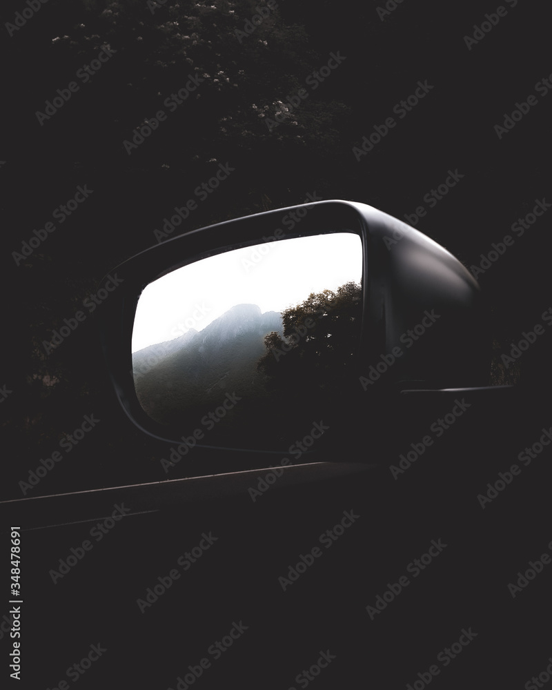 Moody Dramatic Car Window shot showing mountains and trees with dark ...