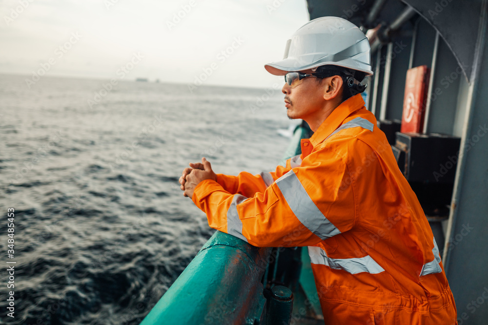 Filipino deck Officer on deck of vessel or ship , wearing PPE personal ...