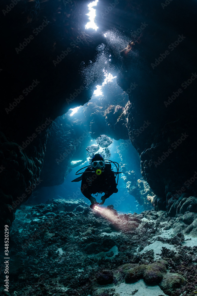 typical underwater cave in a red sea reef with an underwater ...