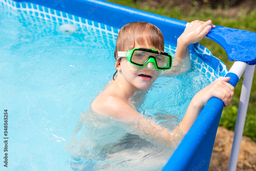 Boy underwater in a mask. A child swims in the pool. A boy in the water ...