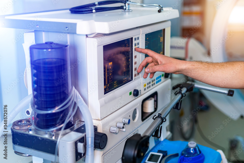 Ventilation of the lungs with oxygen. Nurse`s hand analyses figures on ...