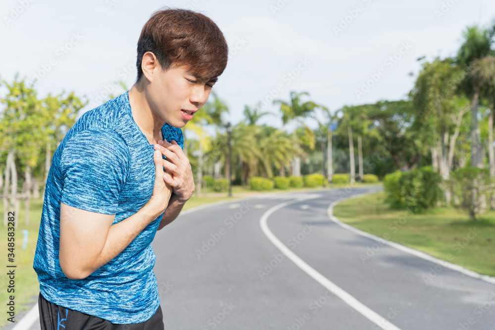 Exhausted male runner suffering painful angina pectoris or asthma ...