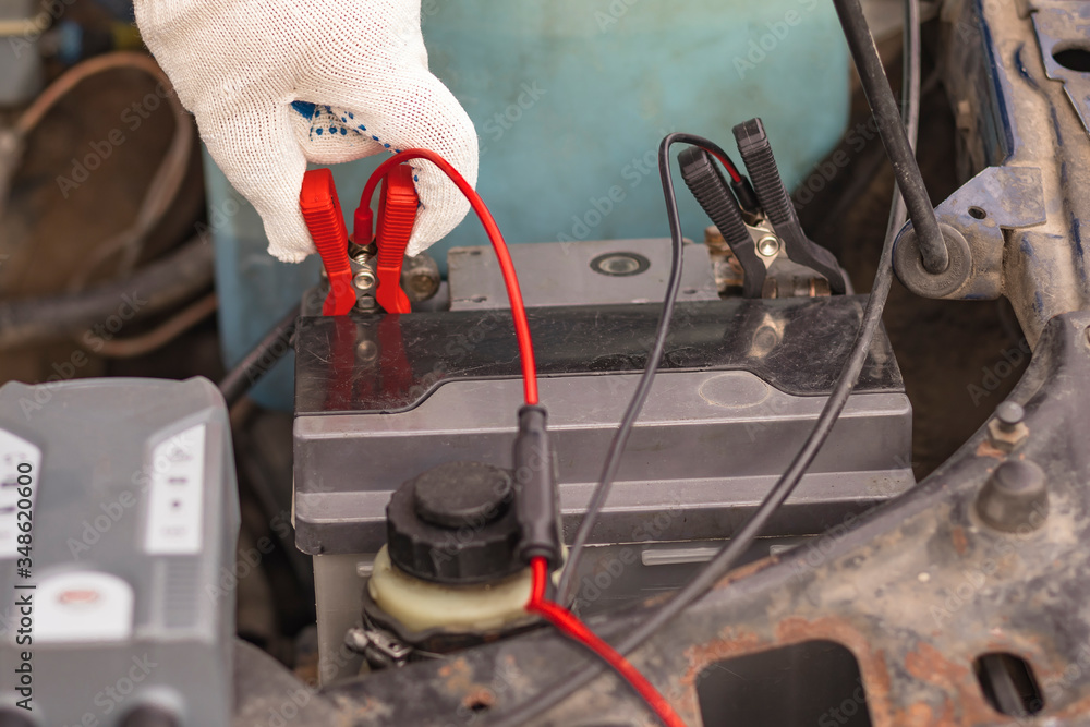 car with internal combustion engine. The hood is open and the battery ...