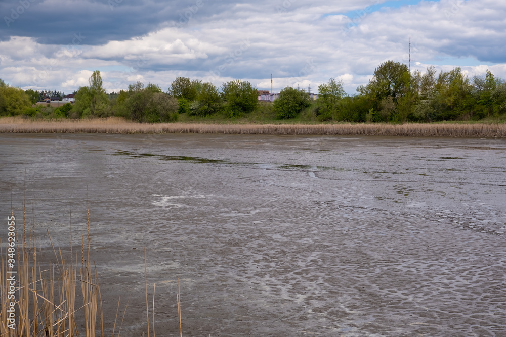 Empty and drained pond. Drought and no water in the landscape. Stock ...