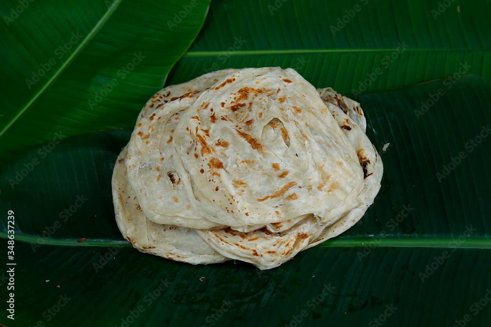 South indian kerala paratha(porotta) isolated on green banana leaf ...