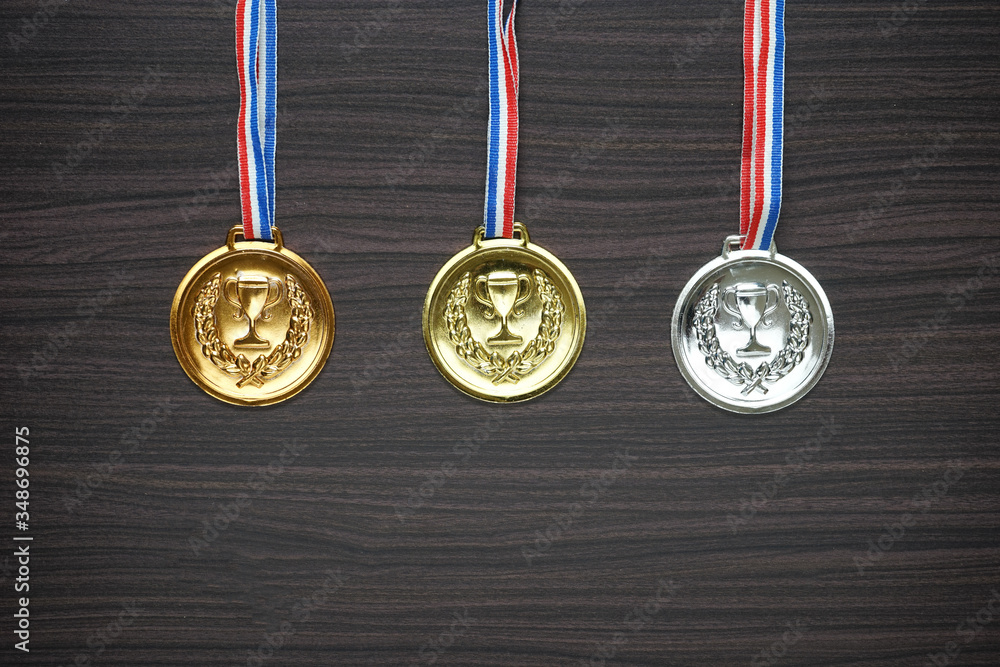 Success concept. Set of gold, silver and bronze medals on top of dark ...