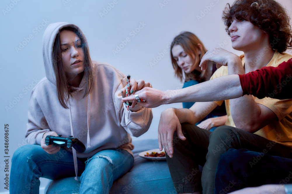 First trip. Young girl going to smoke a joint rolled with cannabis ...