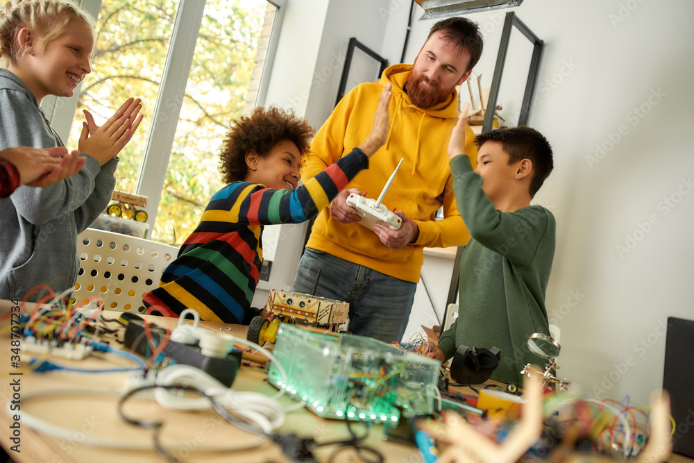 Performance Matters. Young technicians are happy with the result of ...