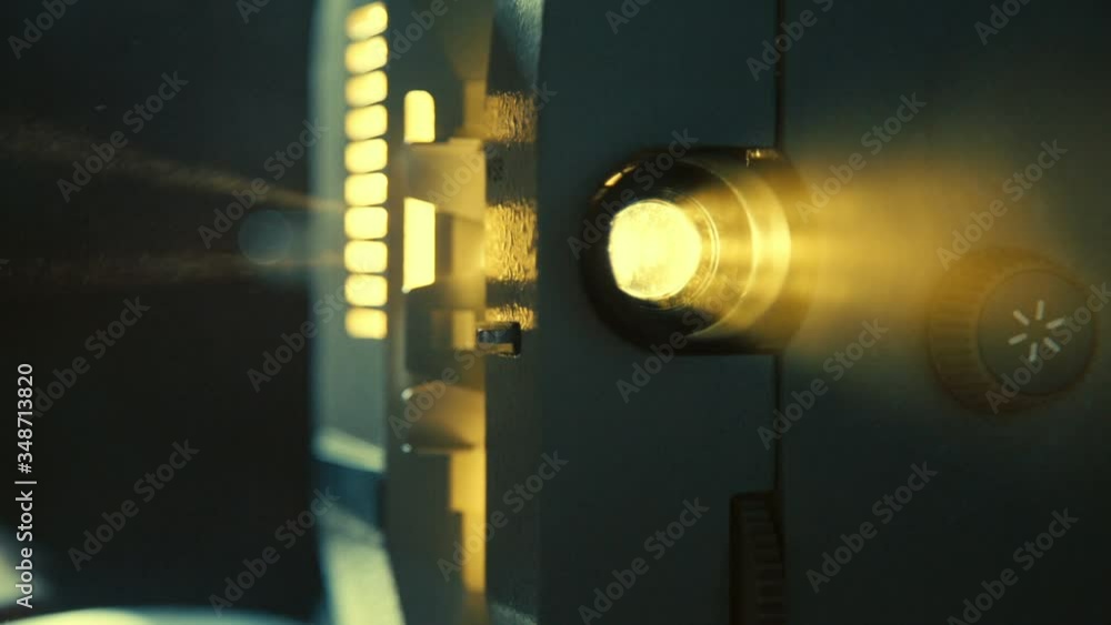 Vintage movie projector is switched on for several minutes, lamp inside ...