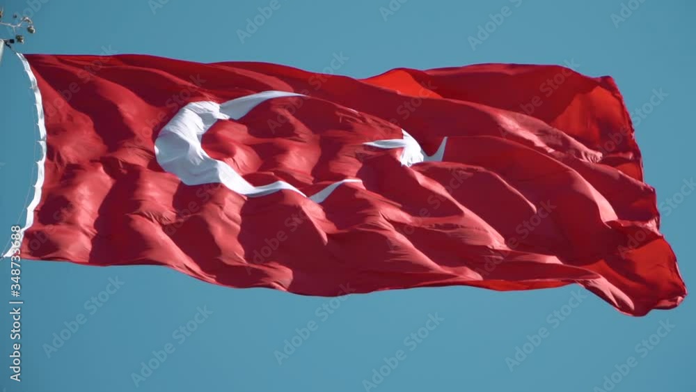National Turkish flag waving at clear blue sky background slow motion ...