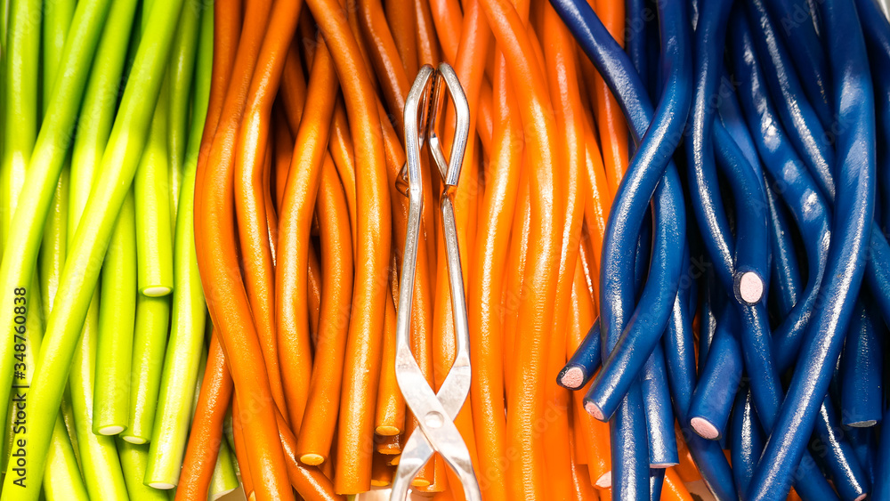 Jelly tubes, Chewing candy. Multi-colored background with long, sweet ...
