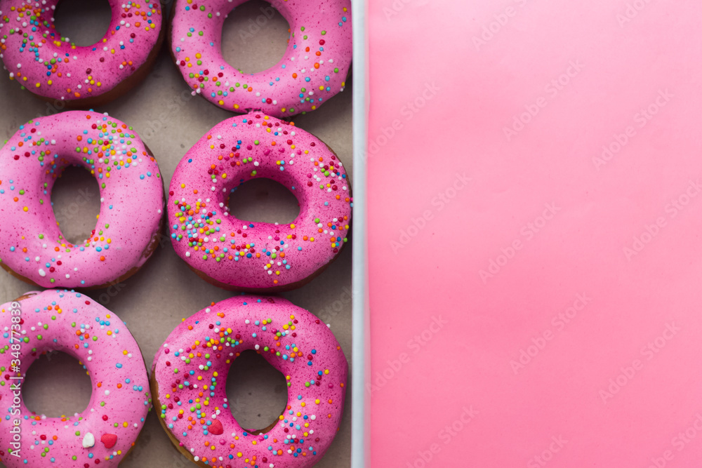 Homemade circle donuts with pink icing and rainbow sprinkles in white ...