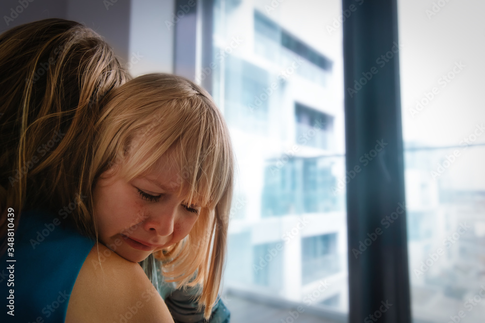 sad crying little girl hugging mother indoors, kids anxiety and stress ...