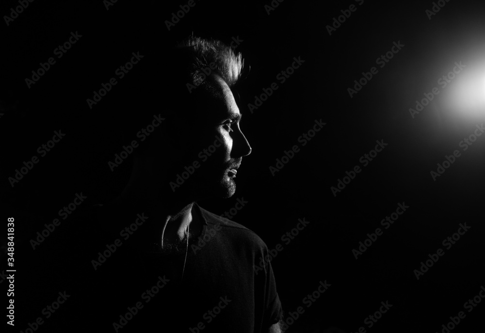 Dramatic profile portrait of male person on dark background Stock Photo ...