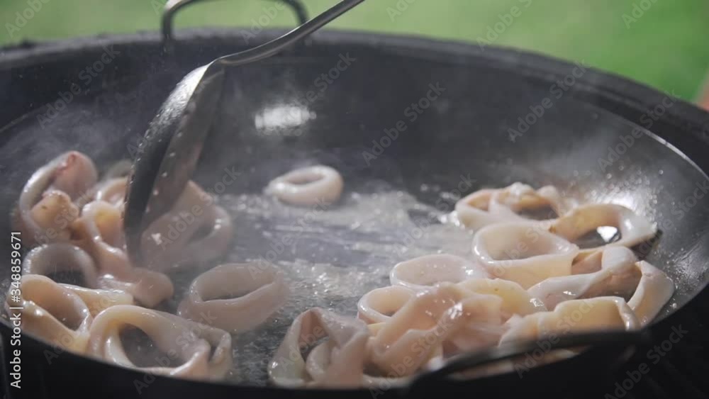 rings of calamari are frying in the boiling oil on the open fire Stock ...
