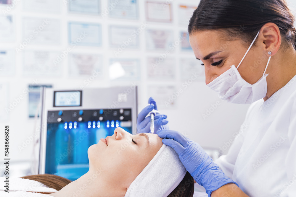Lady is getting injection into her forehead Stock Photo | Adobe Stock