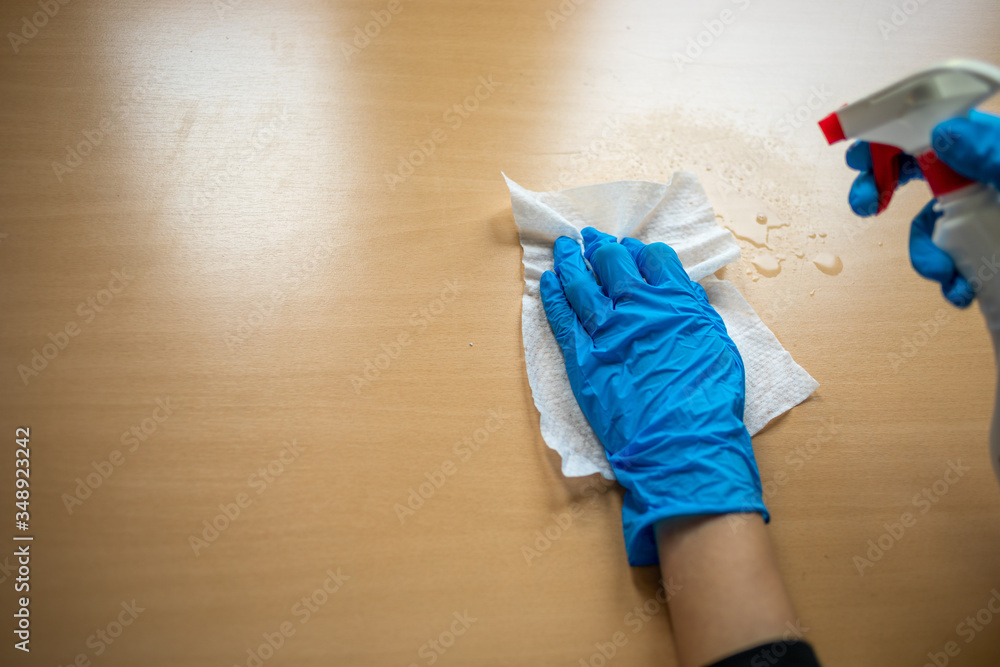 Cleaning home table sanitizing office table surface with disinfectant ...