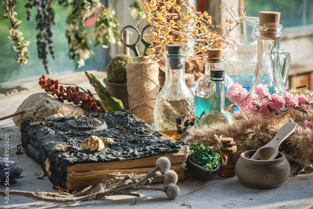 Ancient magic recipe book and magic potions in the bottle on the witch ...