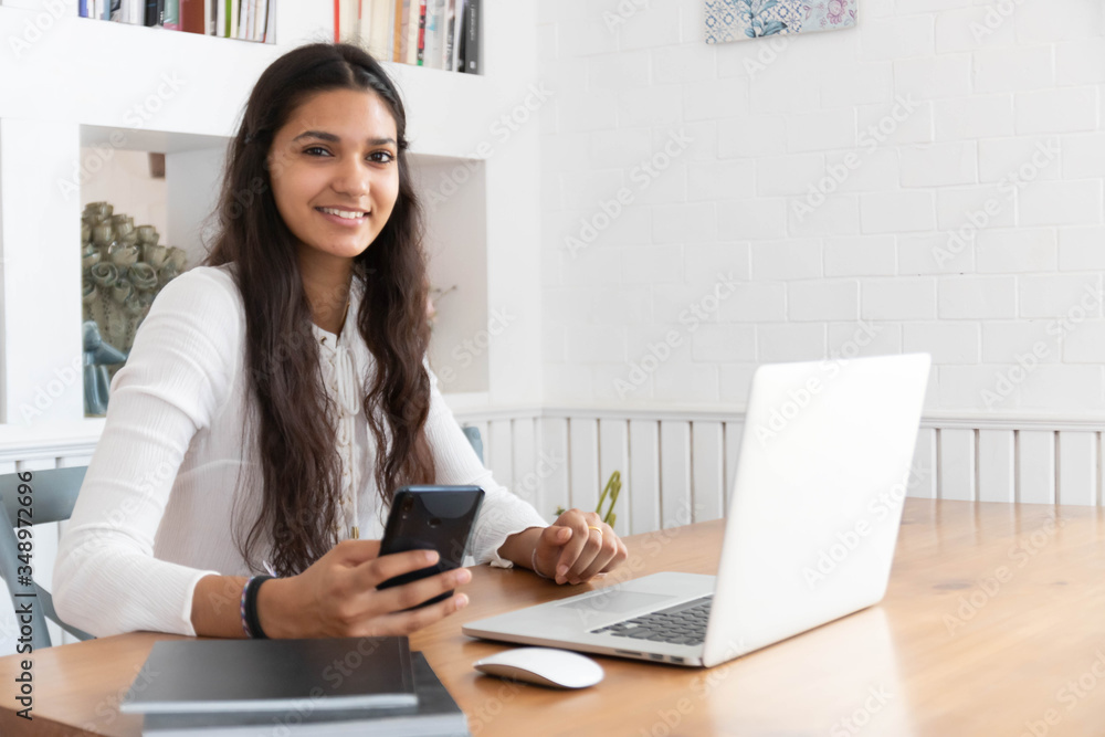 Young girl student sitting in the library and use laptop. Stock Photo ...
