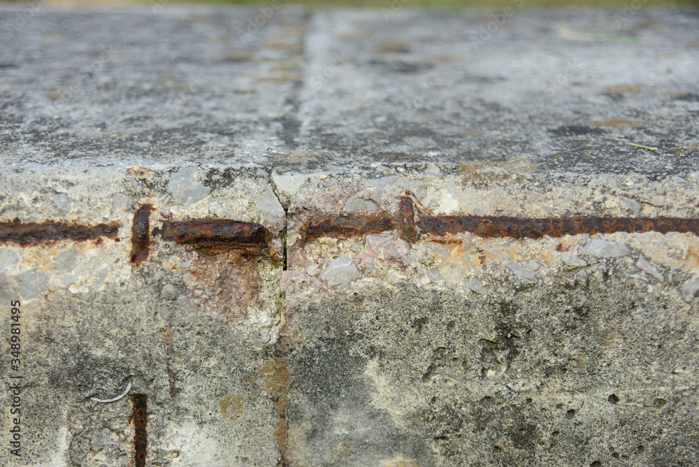 Detail of the exposed rusty reinforcement bars of a concrete structure ...