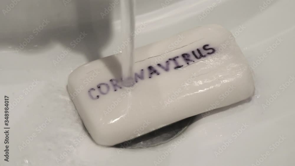 Vidéo Stock Water from tap washes away word coronavirus, which is ...