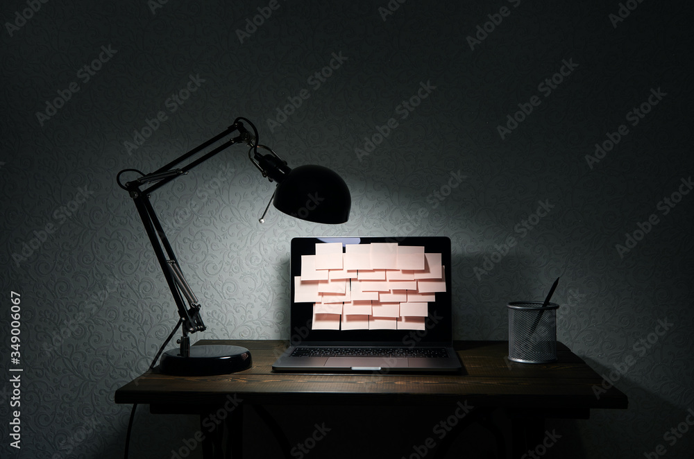 Image of laptop full of sticky notes reminders on screen. Late night ...