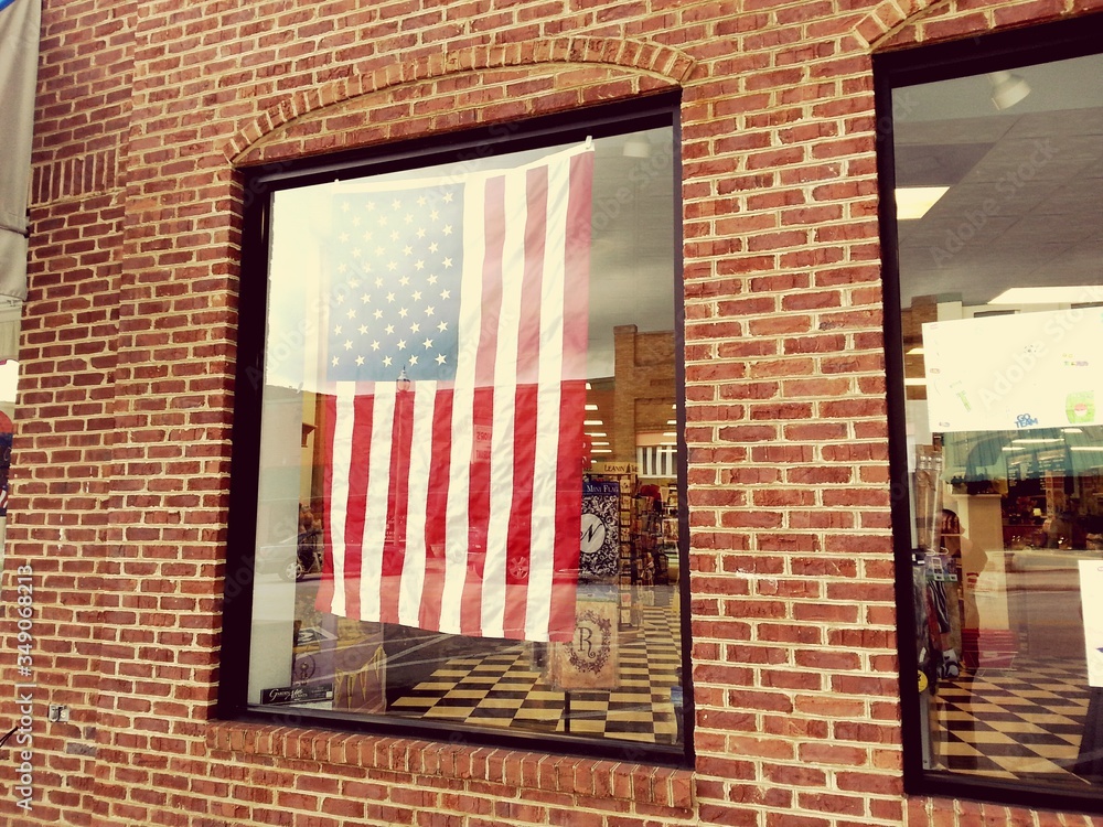 American Flag Hanging From Window In Building Stock Photo | Adobe Stock