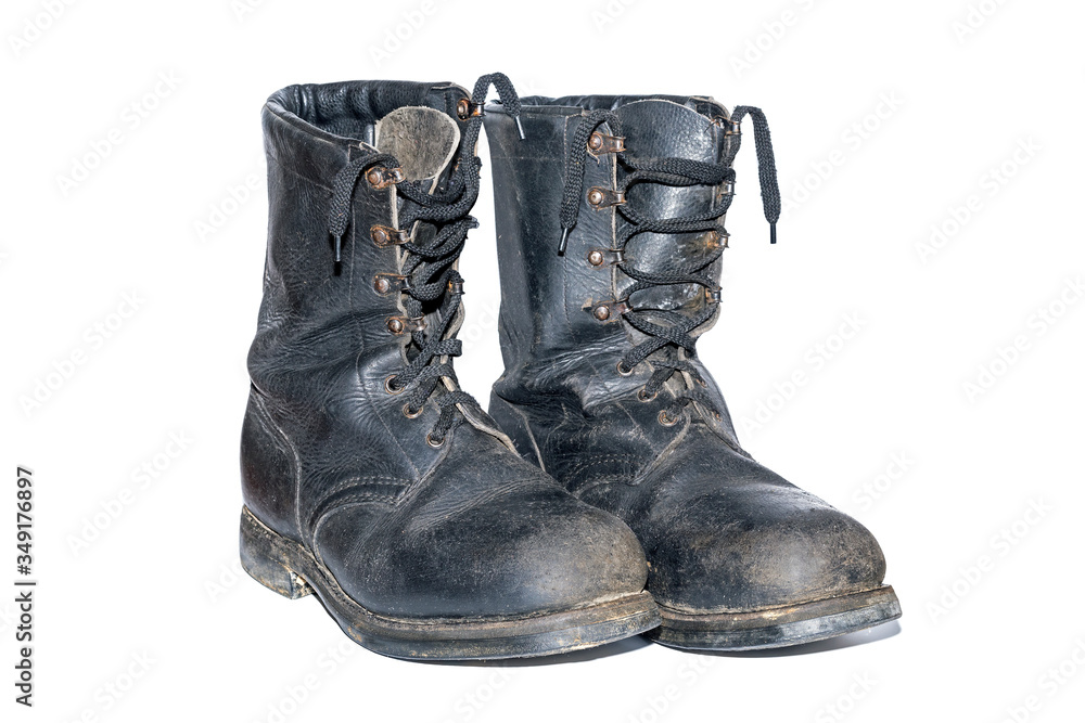 old soldier's boots worn with scratches and untied shoelaces. Old ...