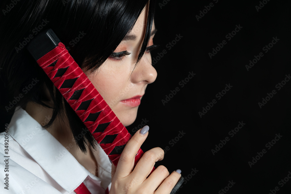 Girl with a katana in a school uniform. Cosplay. On a black background ...