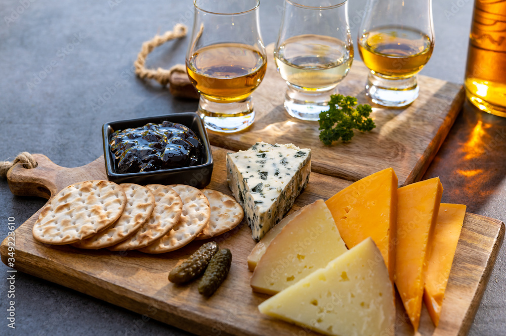 Whiskey and cheese pairing, tasting whisky glasses and plate with ...