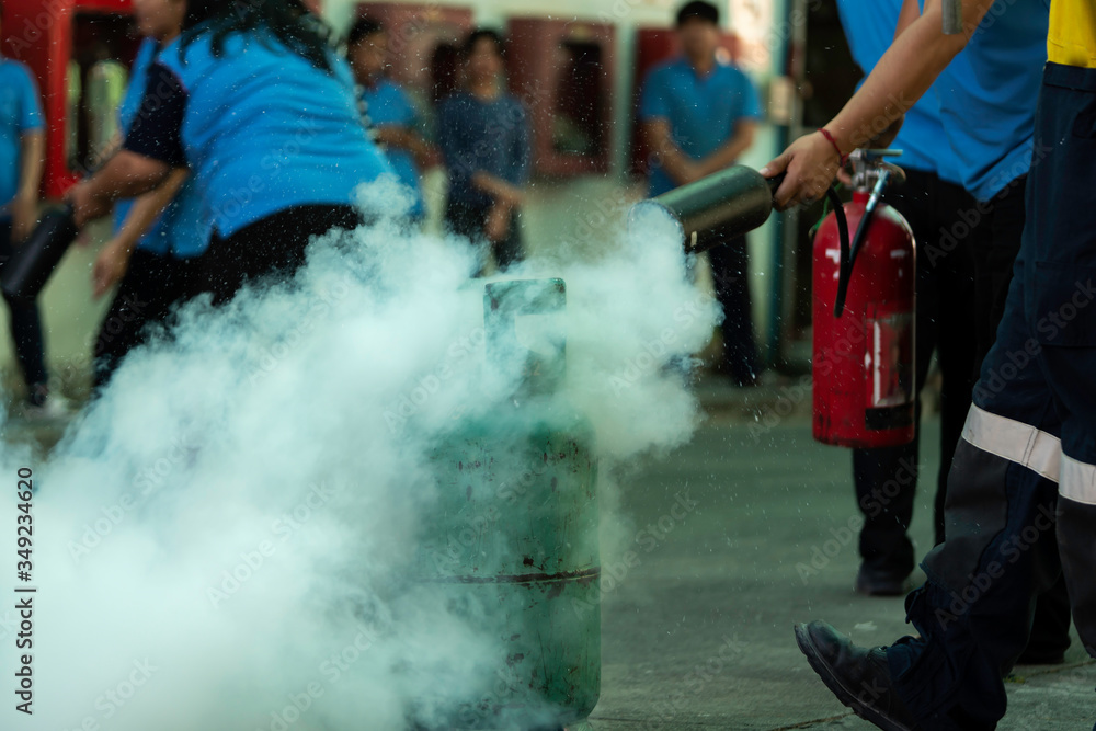 Man teaches how to use fire extinguisher to extinguish fire. Stock ...