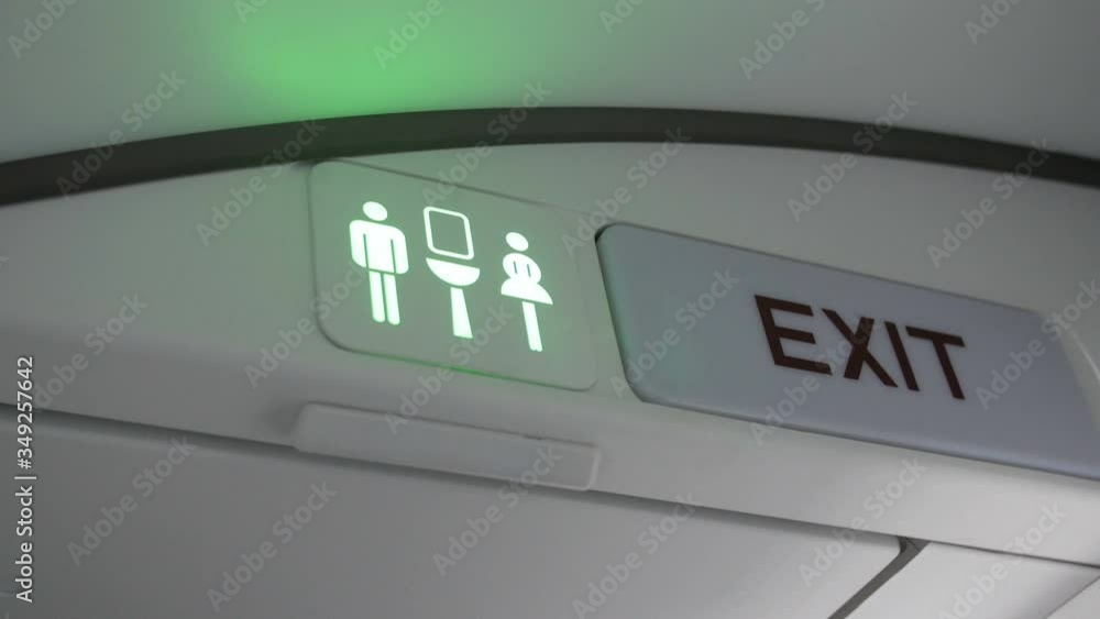 Airplane lavatory sign occupied to available. Shot of airplane lavatory ...