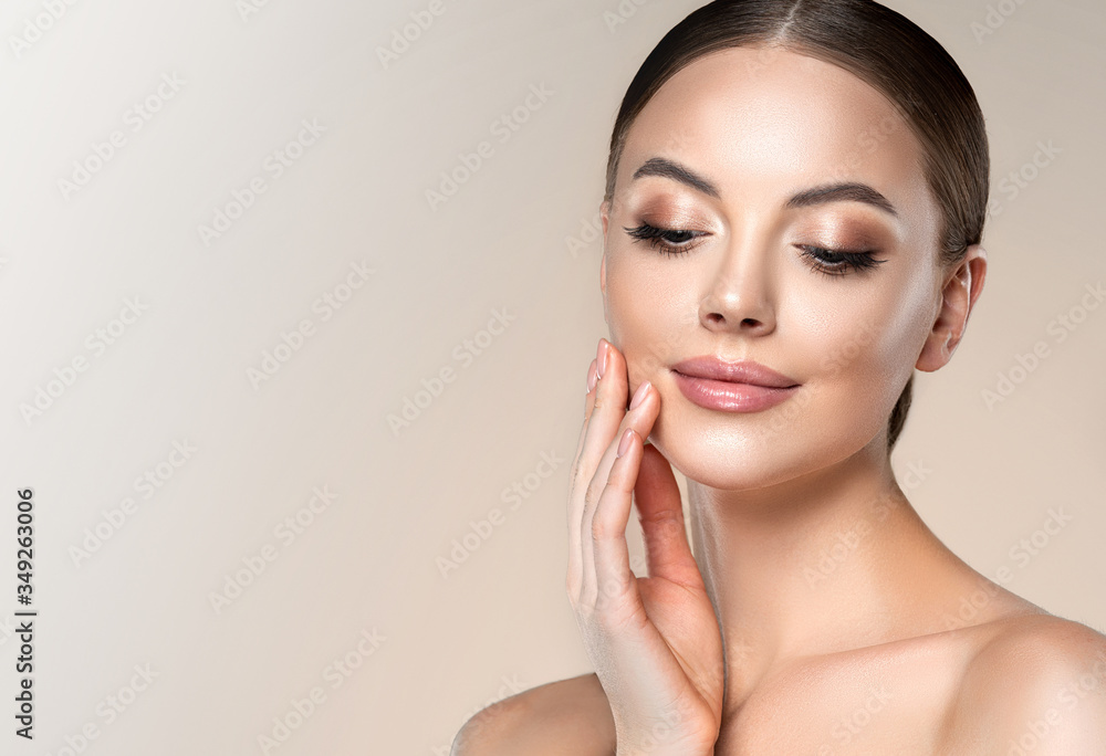 Beautiful young woman with clean fresh skin touching her face . Girl ...