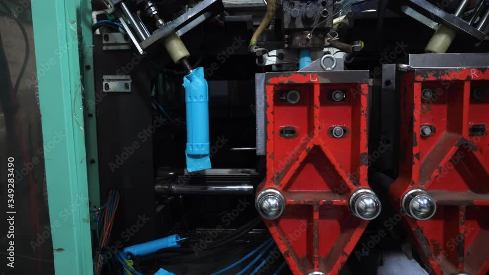The process of blowing plastic tanks in extrusion equipment. Molten ...