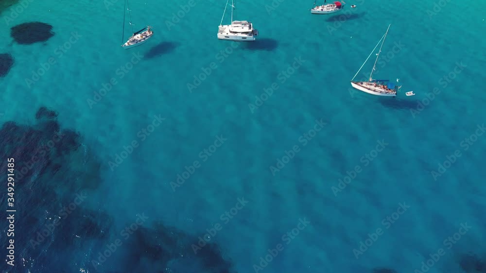 Aerial drone flight over boats and yachts floating on water close to ...