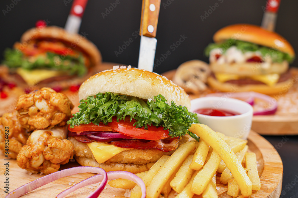 Combo set of fast food. Juicy hamburger, French fries, chicken legs and ...