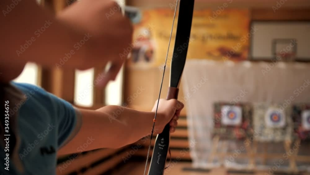 The archer shoots a bow and misses. Preparing for shooting indoor ...