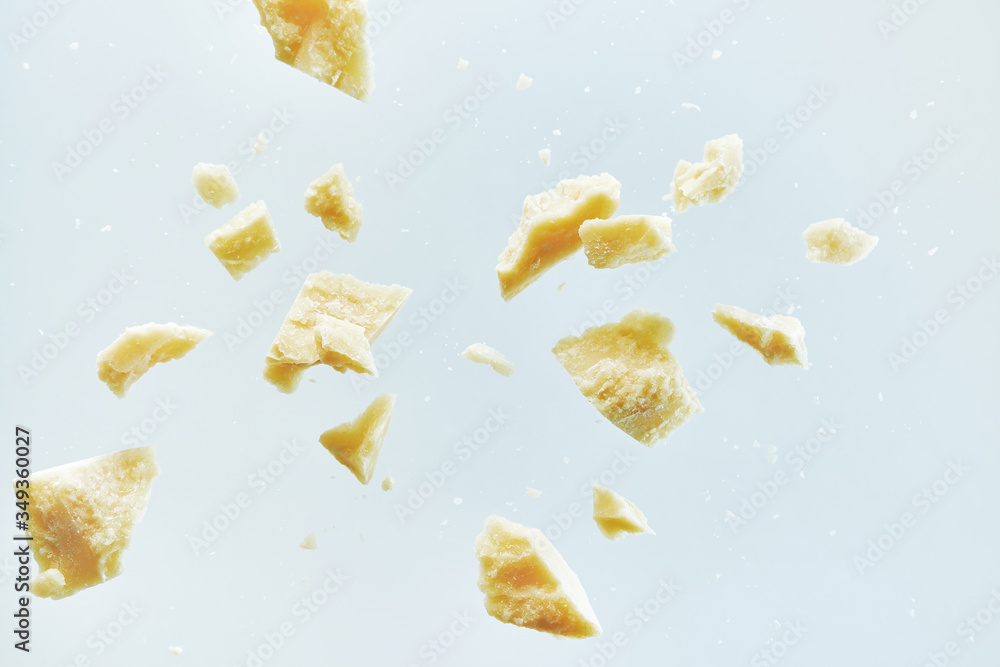 Flying Parmesan cheese explodes and splits in different directions with ...