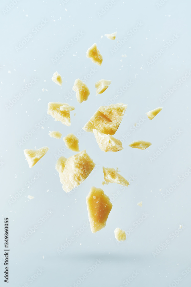 Flying parmesan cheese explodes and splits in different directions with ...
