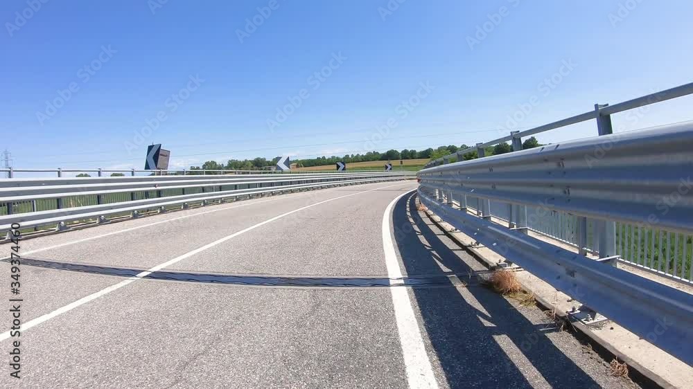 curve on a modern paved road with side guard-rail galvanized metal ...