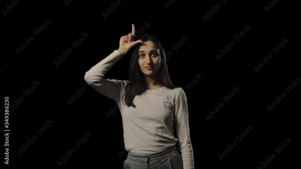 Young Indian woman giving the loser hand sign. Transparent isolated ...