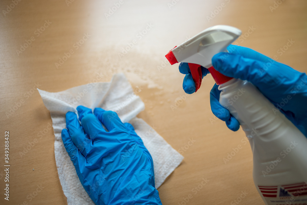 Cleaning home table sanitizing office table surface with disinfectant ...