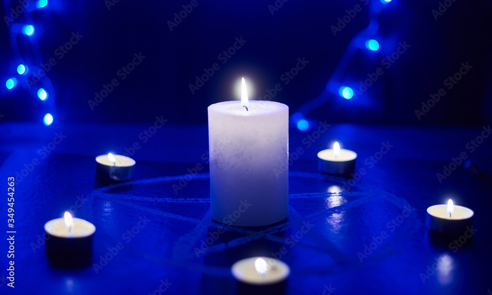 Pentagram and burning candles. The magical ritual of Satanism ...