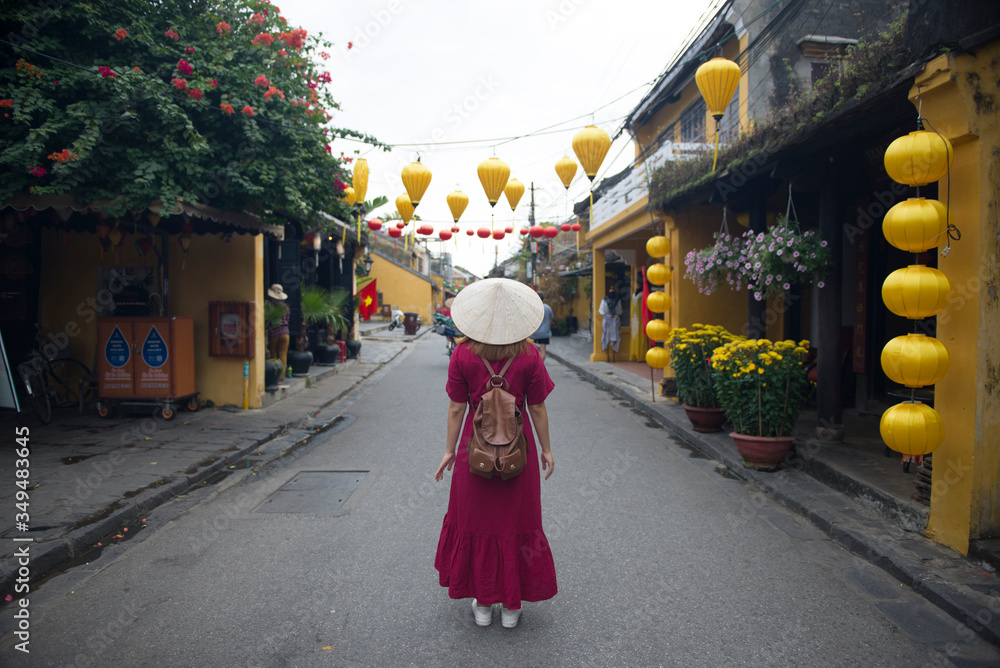 Tourist woman is wearing Non La (Vietnamese tradition hat) and enjoy ...