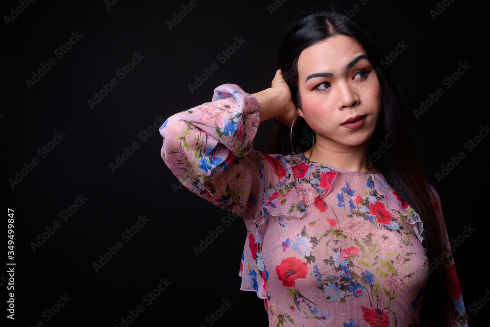 Young beautiful Asian transgender woman against black background Stock ...