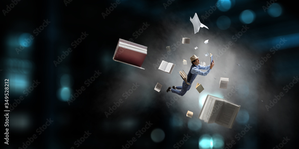 Flying man with a book Stock Photo | Adobe Stock
